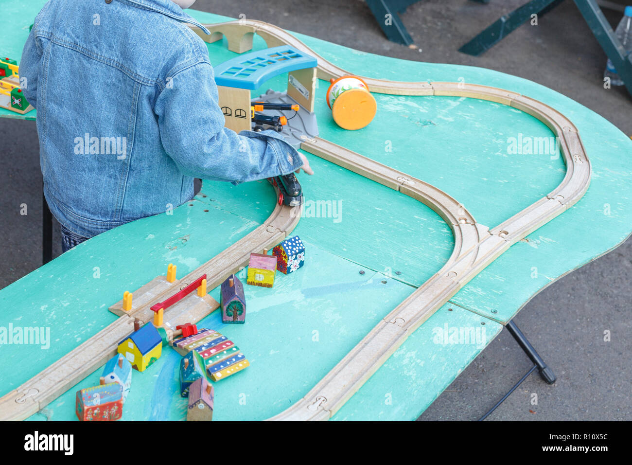 Autistic kid play alone with train toys Stock Photo - Alamy