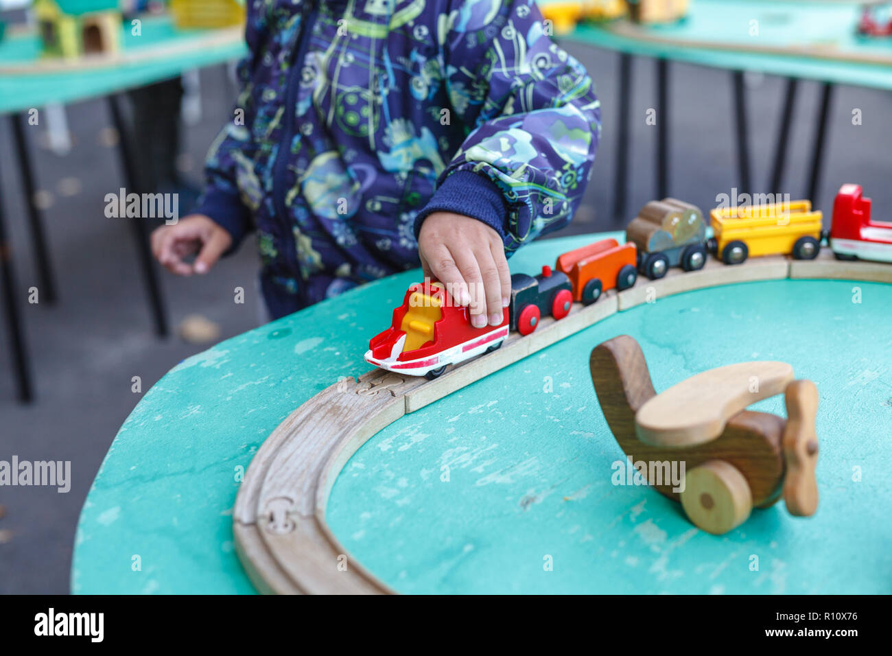 Little autistic boy playing with toy outdoor Stock Photo - Alamy
