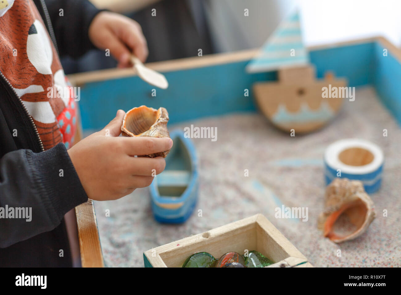 Little autistic boy playing with toy outdoor Stock Photo - Alamy