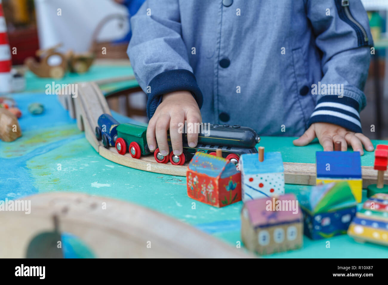 Little autistic boy playing with toy outdoor Stock Photo - Alamy