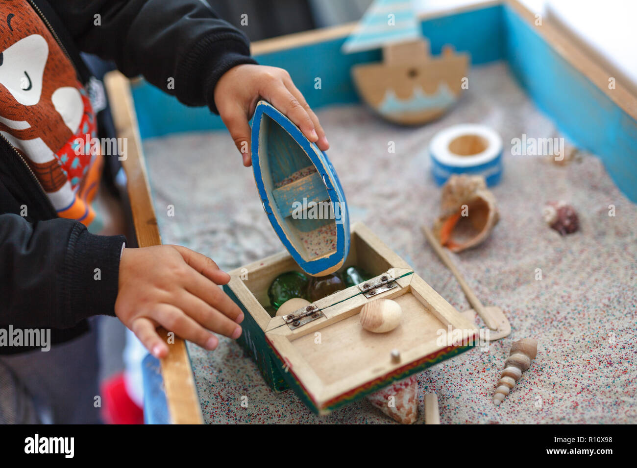 Autistic kid play alone with train toys Stock Photo - Alamy