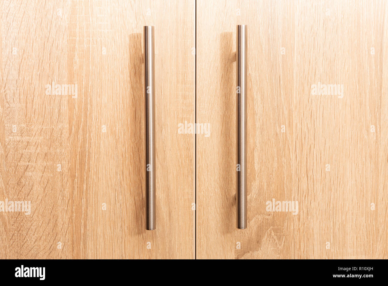 Wooden wardrobe metal vertical door handles close-up Stock Photo - Alamy