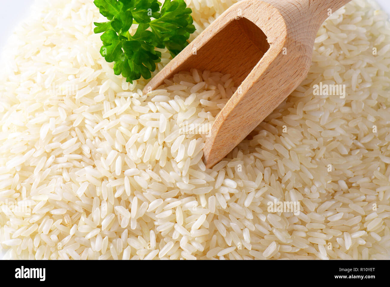 Wooden scoop in a heap of rice Stock Photo - Alamy