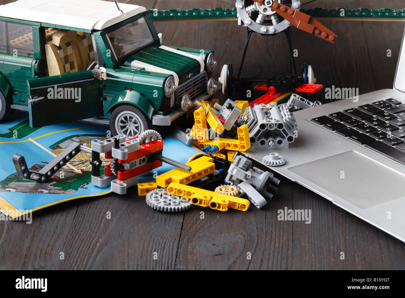 Colorful plastic constructor, toy details on a wooden background. Parts ...