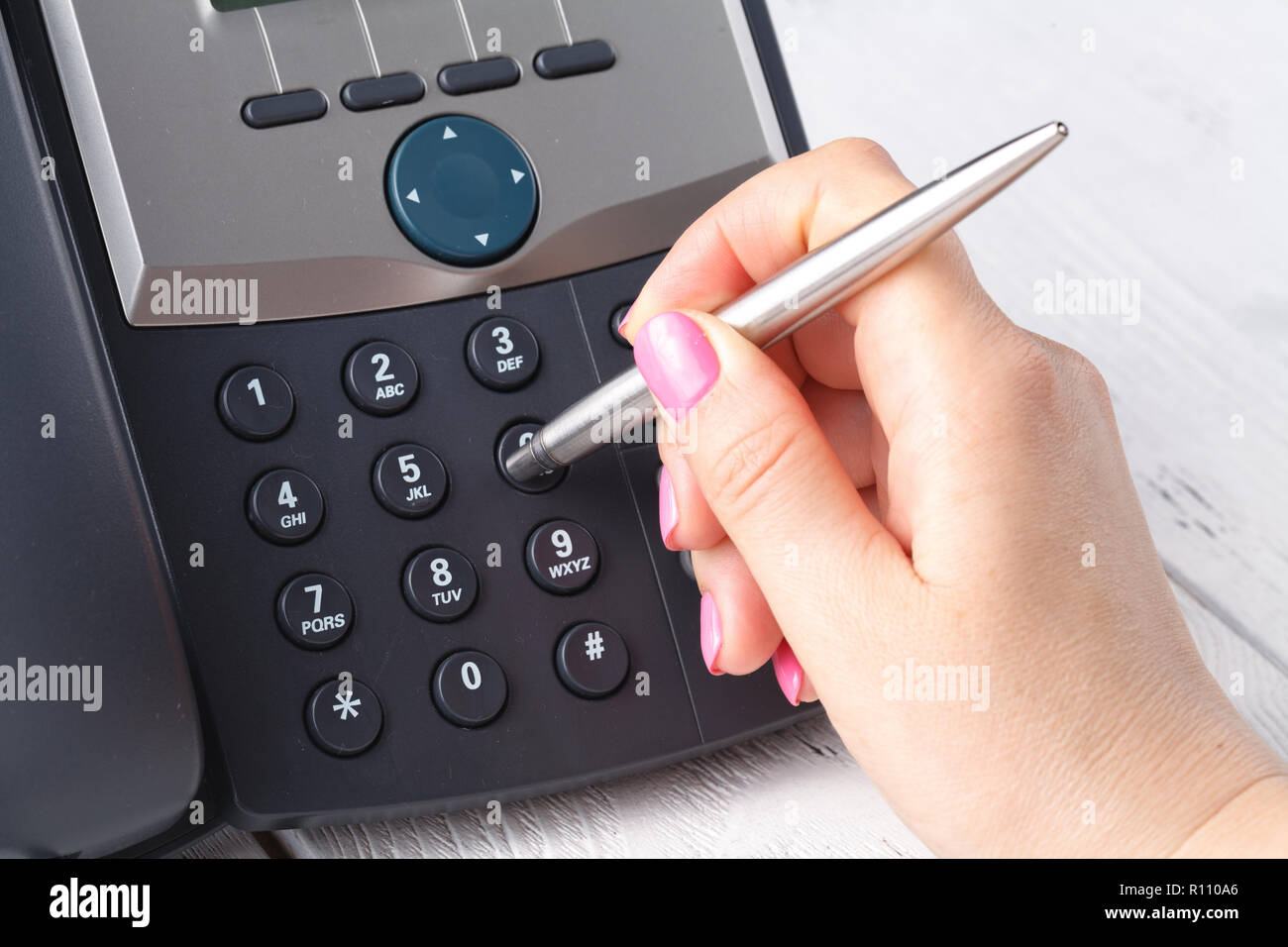 Call center or office phone concept, female finger press number on ...