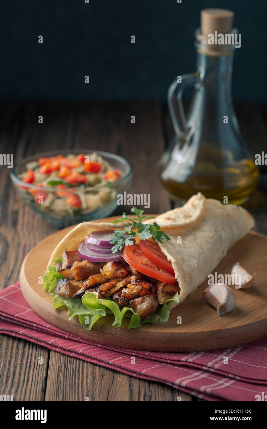 Doner kebab is lying on the cutting board. Shawarma with chicken meat ...