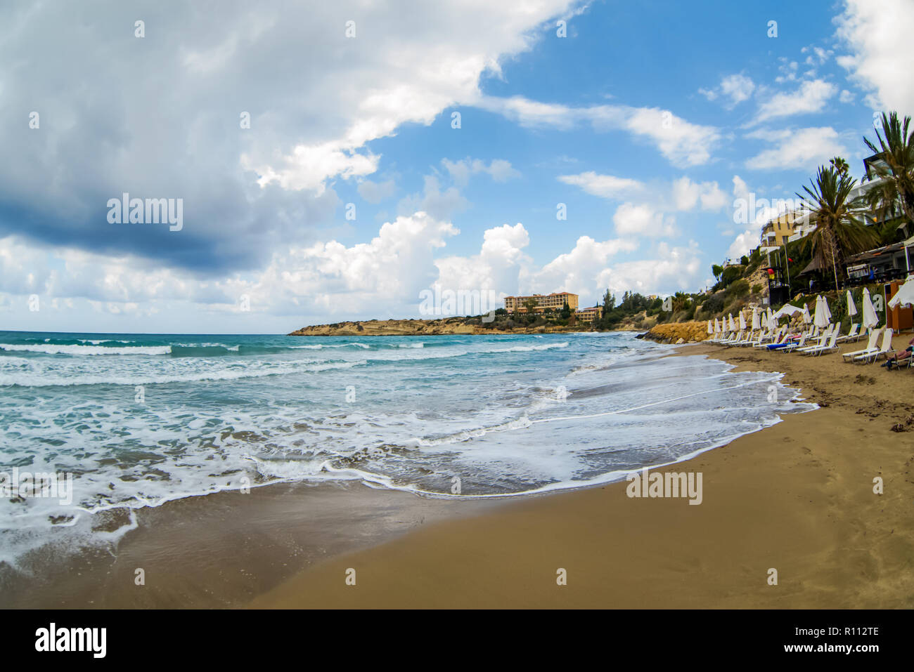 sea surface and sunny summer rocky coastline with clouds Stock Photo ...