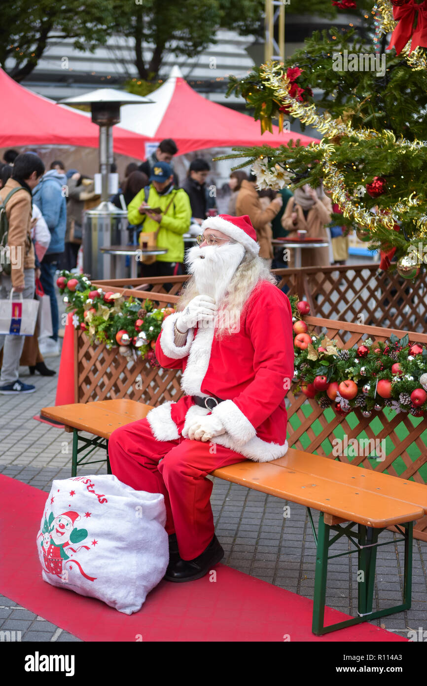 Christmas in Japan. Lonely Santa sitting on a bench Stock Photo - Alamy