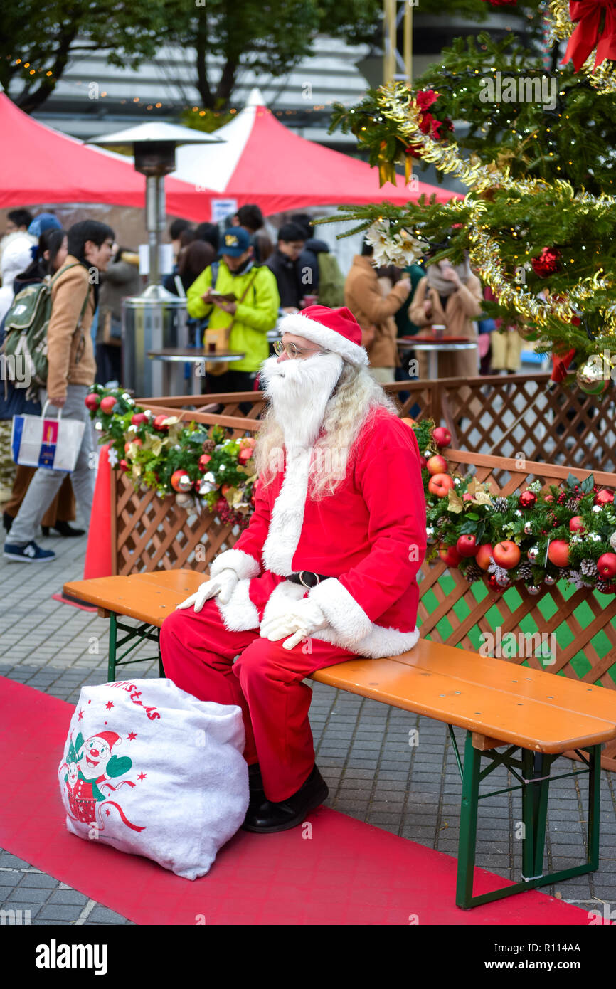 Christmas in Japan. Lonely Santa sitting on a bench Stock Photo - Alamy