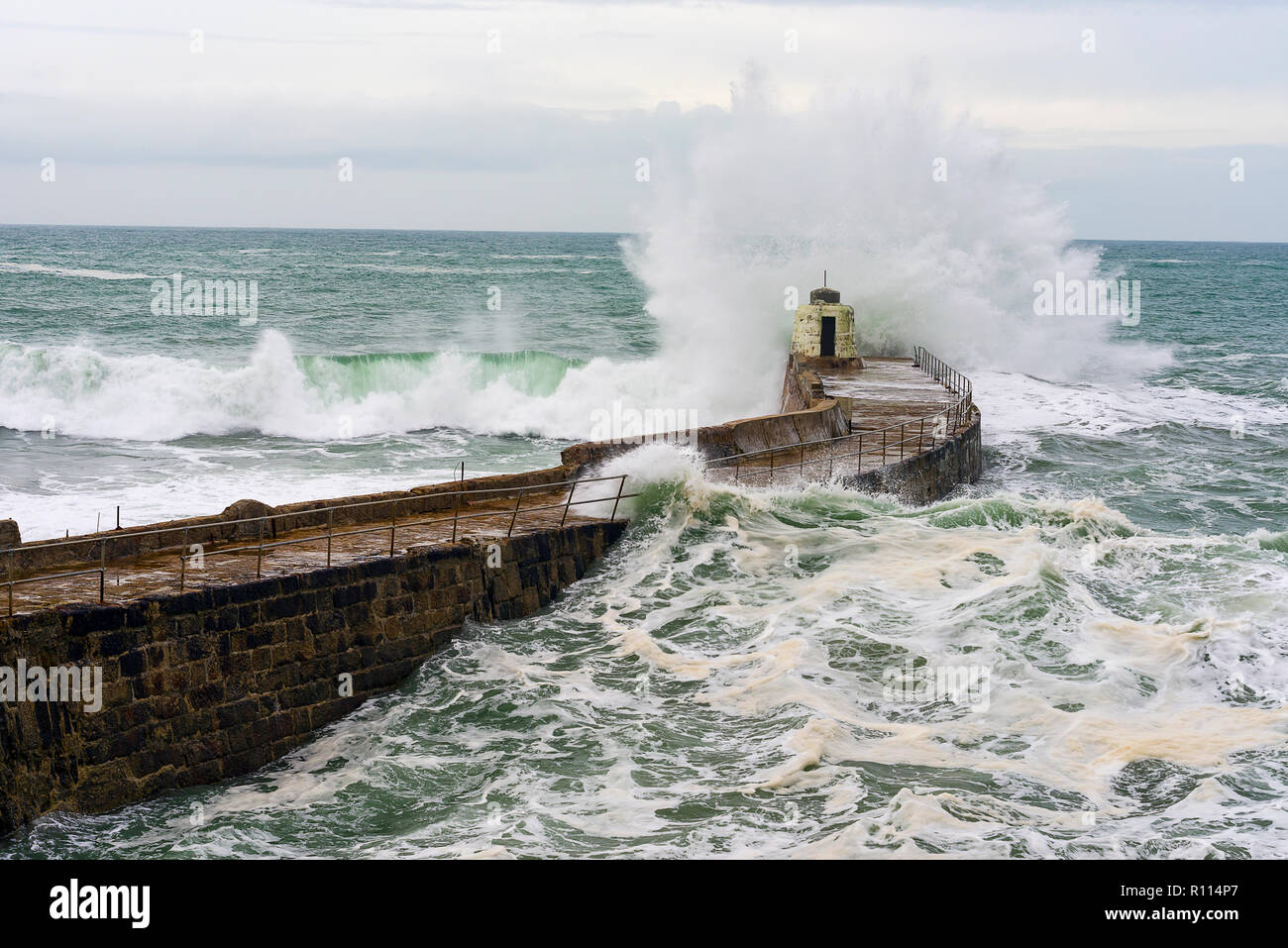 Portreath hit by huge waves after a typical Cornish storm Stock Photo ...
