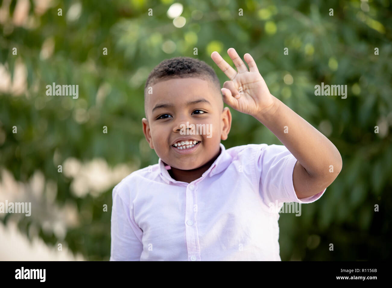Small latin child counting with his fingers in the garden Stock Photo ...