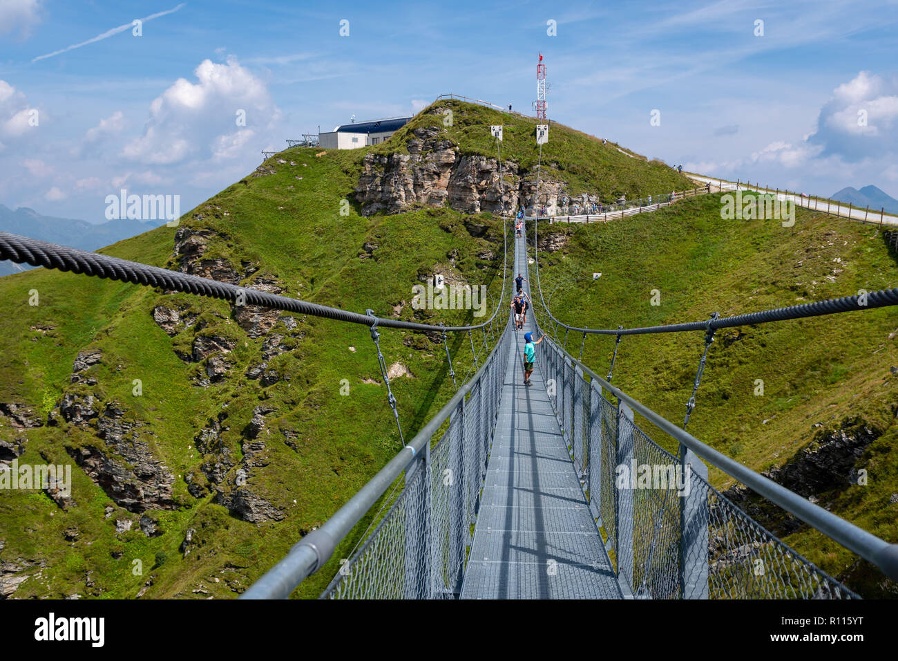 BAD GASTEIN, AUSTRIA - AUGUST 06, 2018: People cross a suspension ...