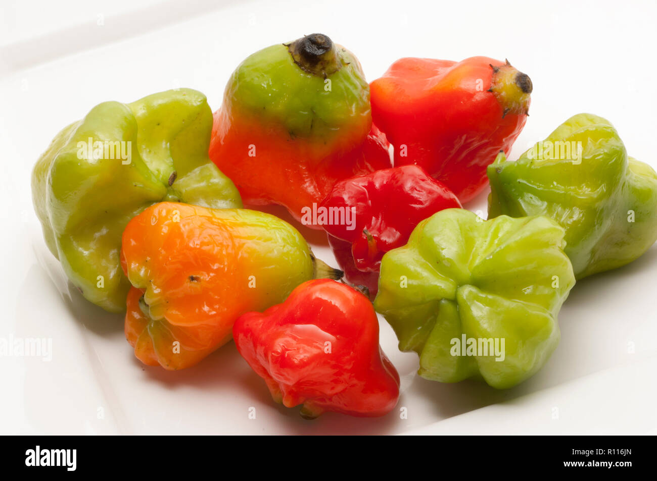 Bellpeppers of various colours on a white plare Stock Photo - Alamy