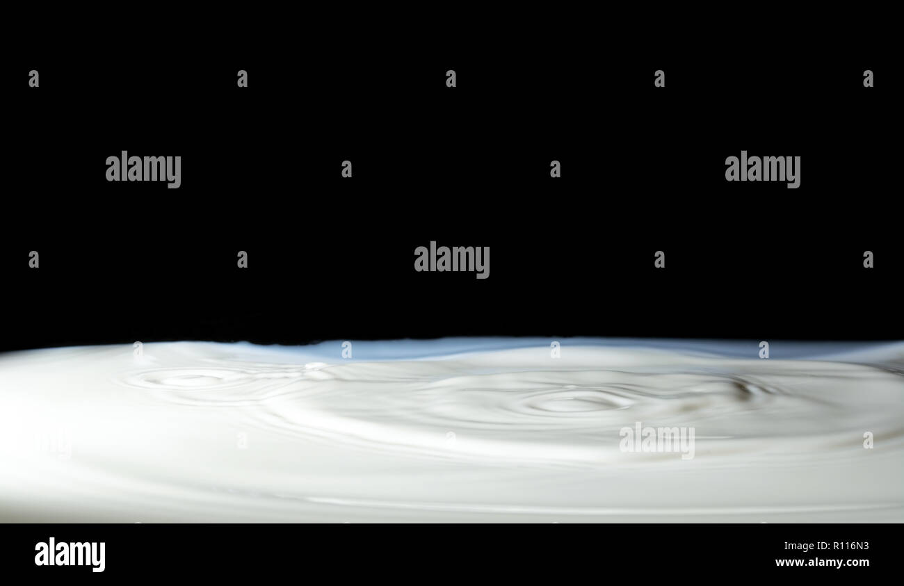 splashing milk isolated on black background Stock Photo - Alamy