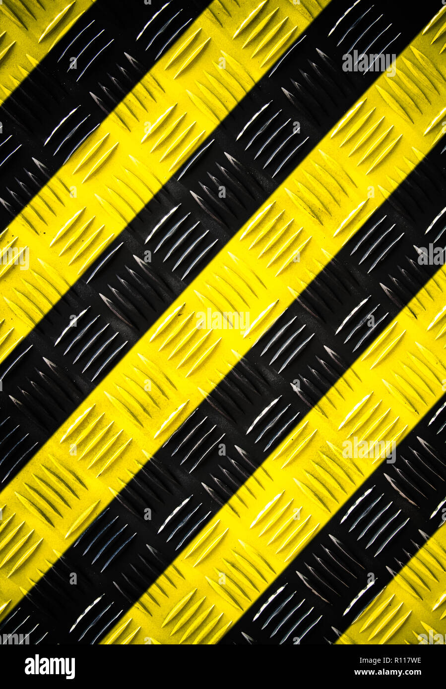 Warning sign yellow and black stripes painted over steel checker ...