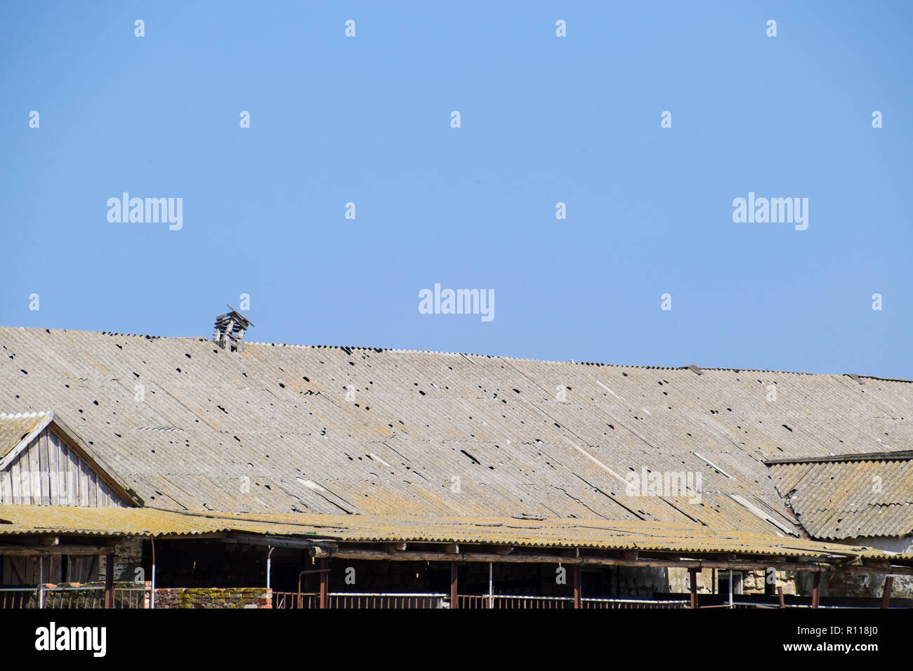 Old farm building. Leaky slate roof on the farm. The consequences of ...