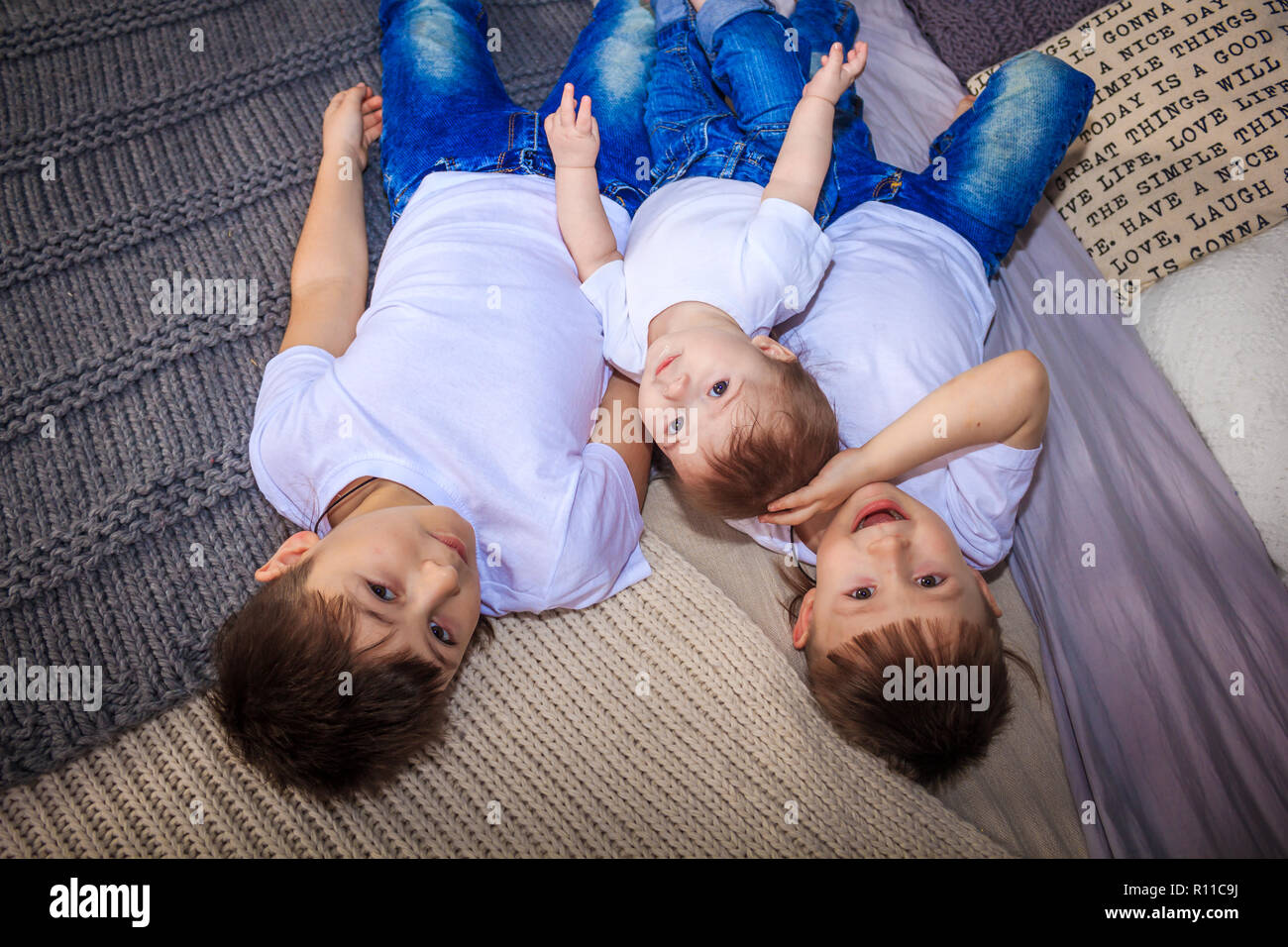 three brothers are lying on the bed. brotherly love big family, many ...
