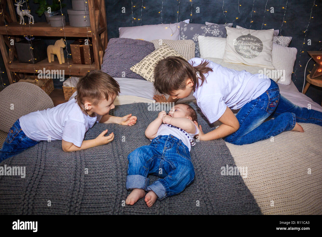 three brothers are lying on the bed. brotherly love big family, many ...