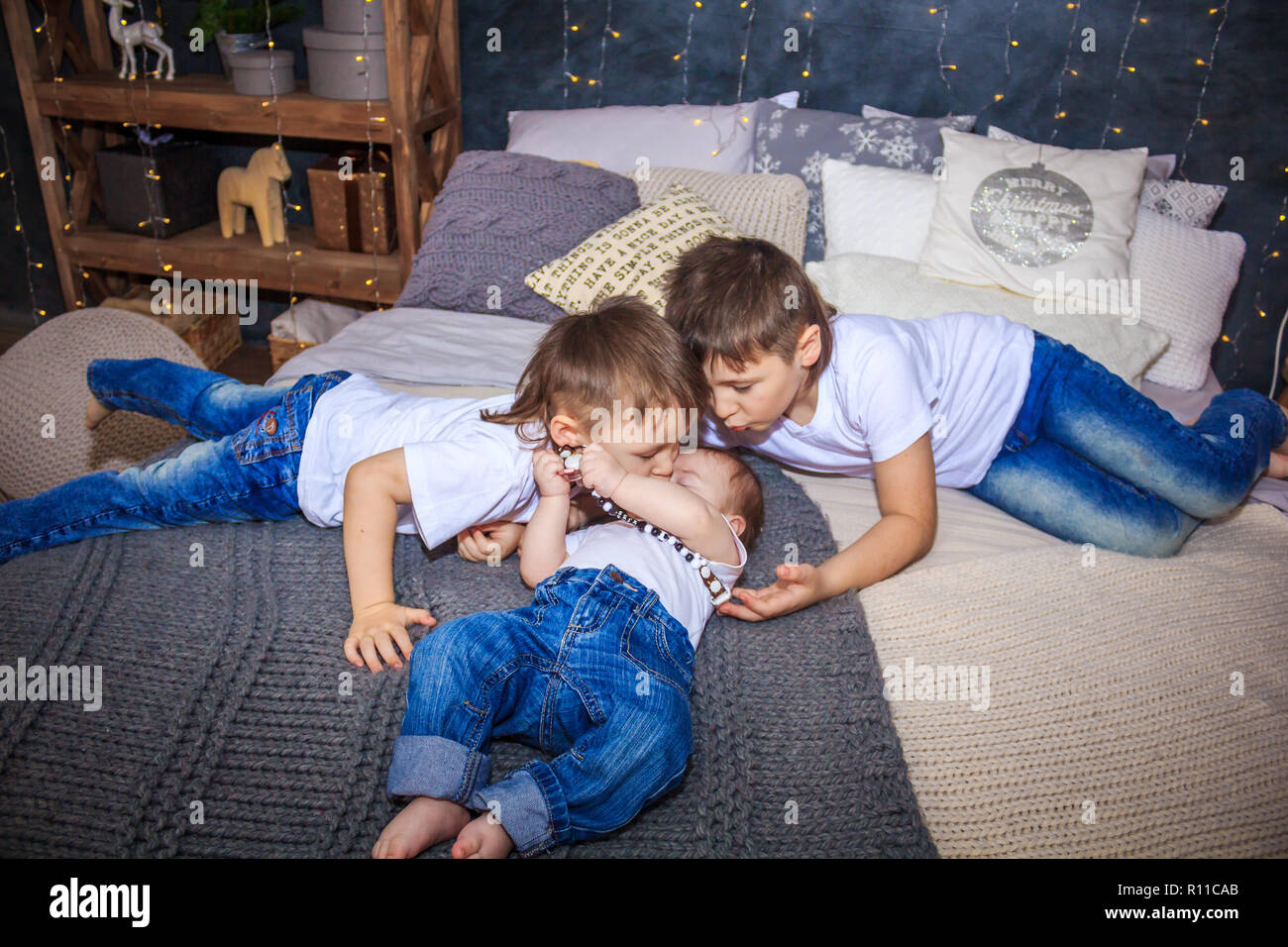 three brothers are lying on the bed. brotherly love big family, many ...