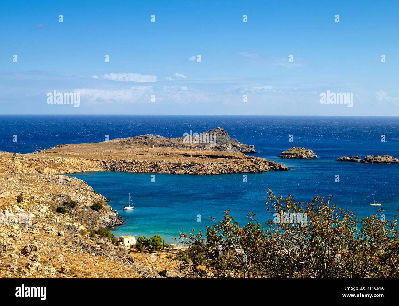 The beautiful crystal clear waters of Lindos Bay, situated directly ...