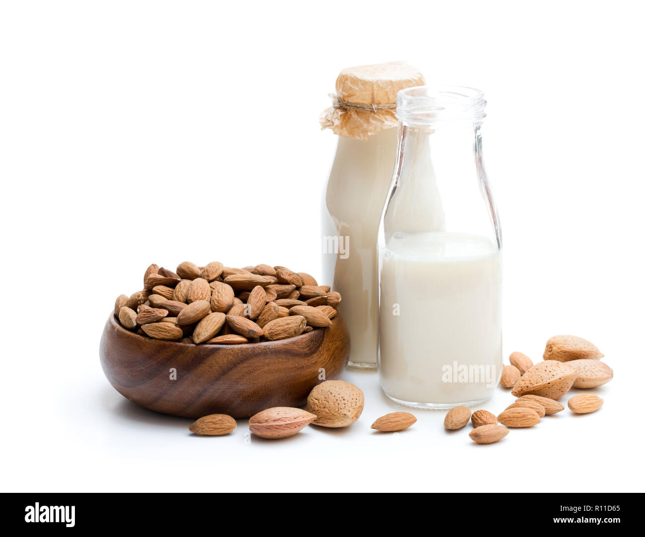 Almond milk in glass bottles isolated on white Stock Photo - Alamy