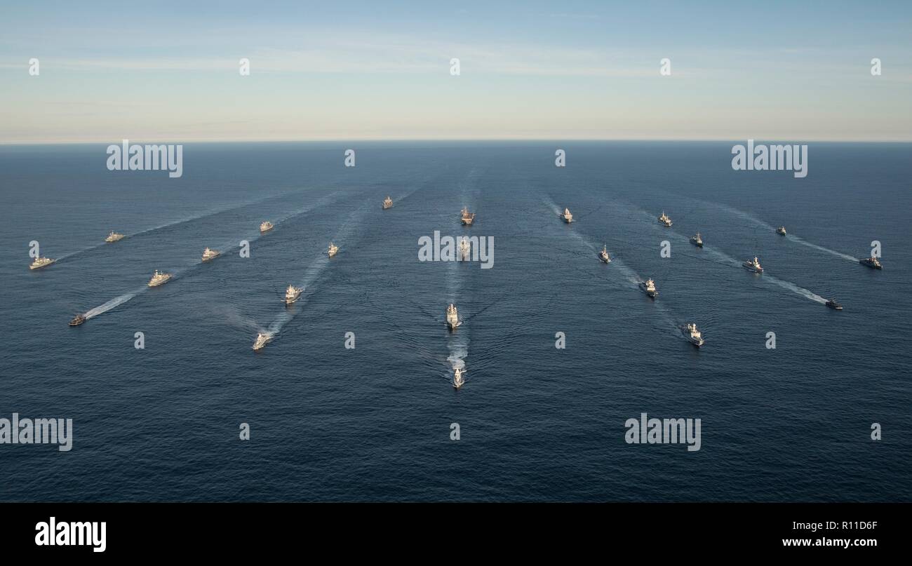 Twenty-four naval warships from 14 nations assemble in formation during ...