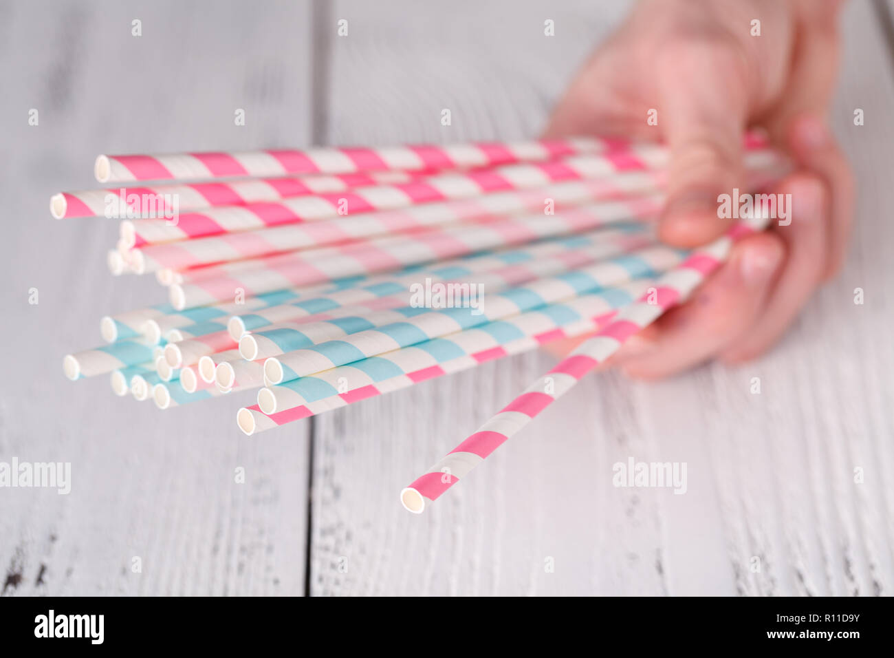 striped paper disposable tubes in a woman hand Stock Photo - Alamy