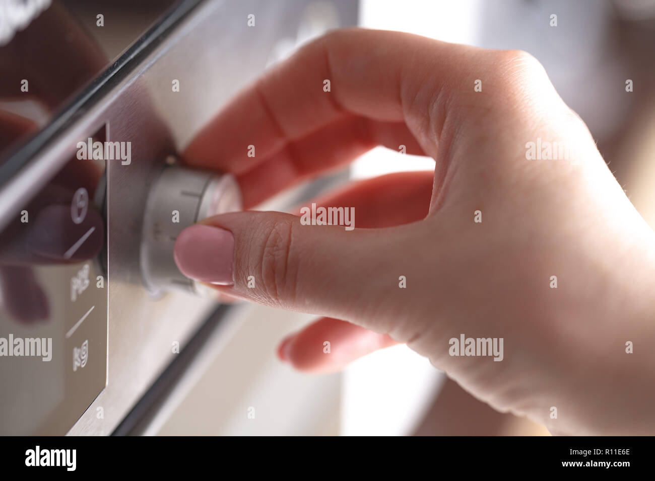 Using microwave oven, close up photo Stock Photo - Alamy