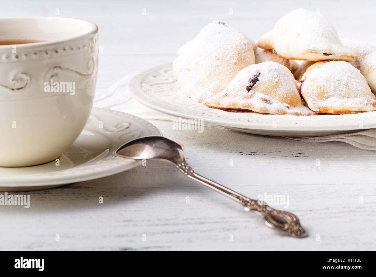 Baked sweet patty filled with berry jam on a plate. Small berry pie ...