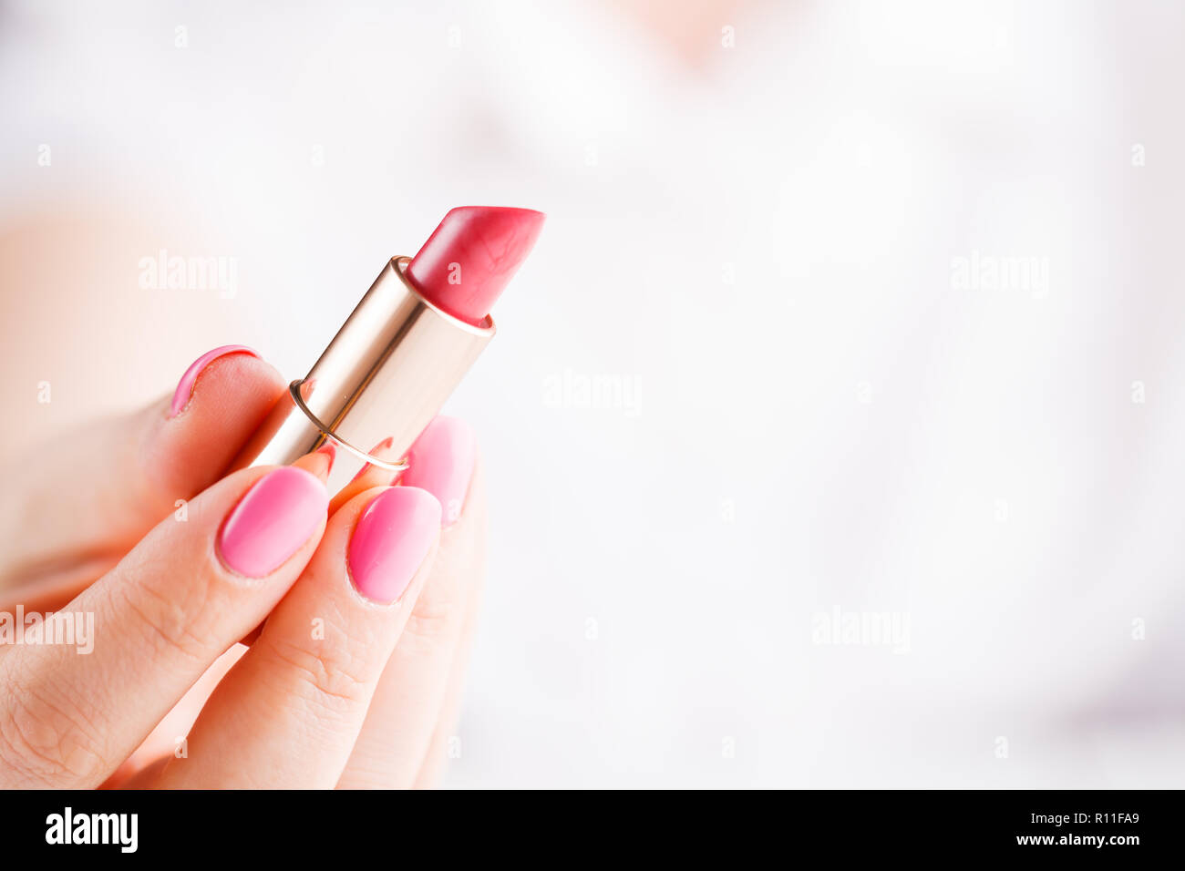 Red lipstick in a woman's hand Stock Photo - Alamy