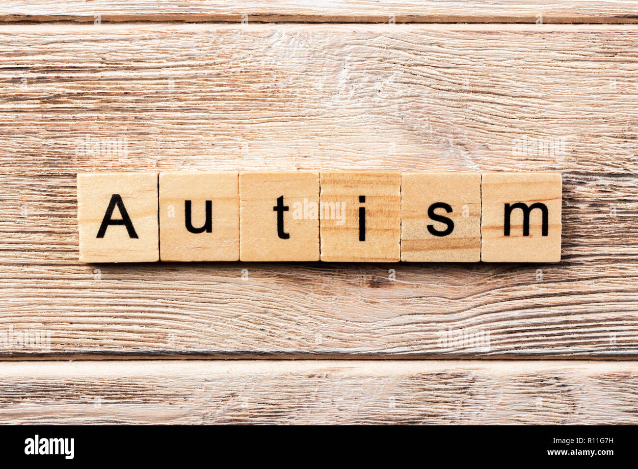 autism word written on wood block. autism text on table, concept Stock ...