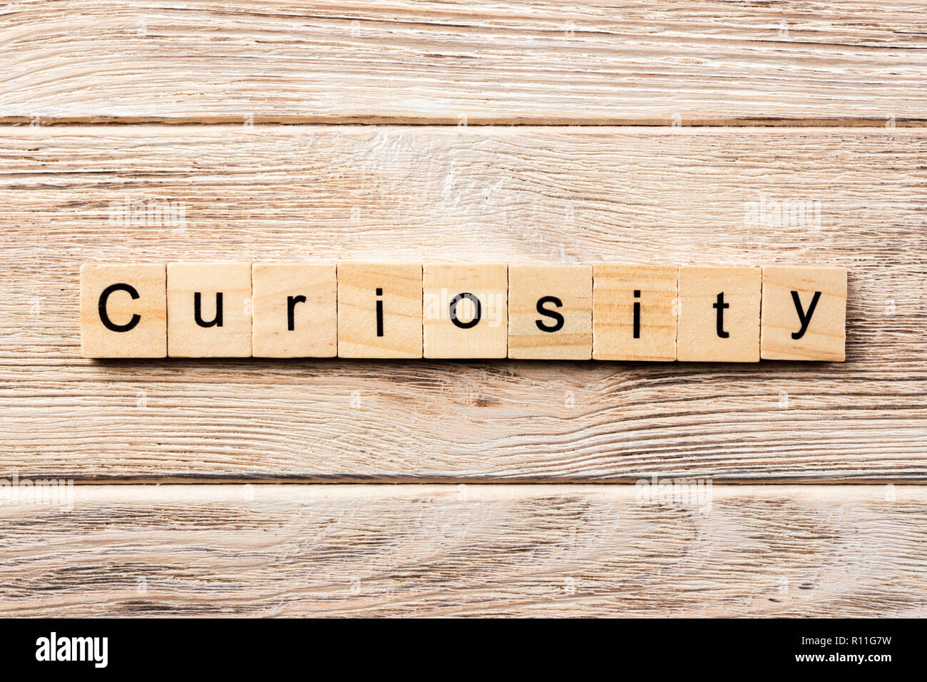curiosity word written on wood block. curiosity text on table, concept ...