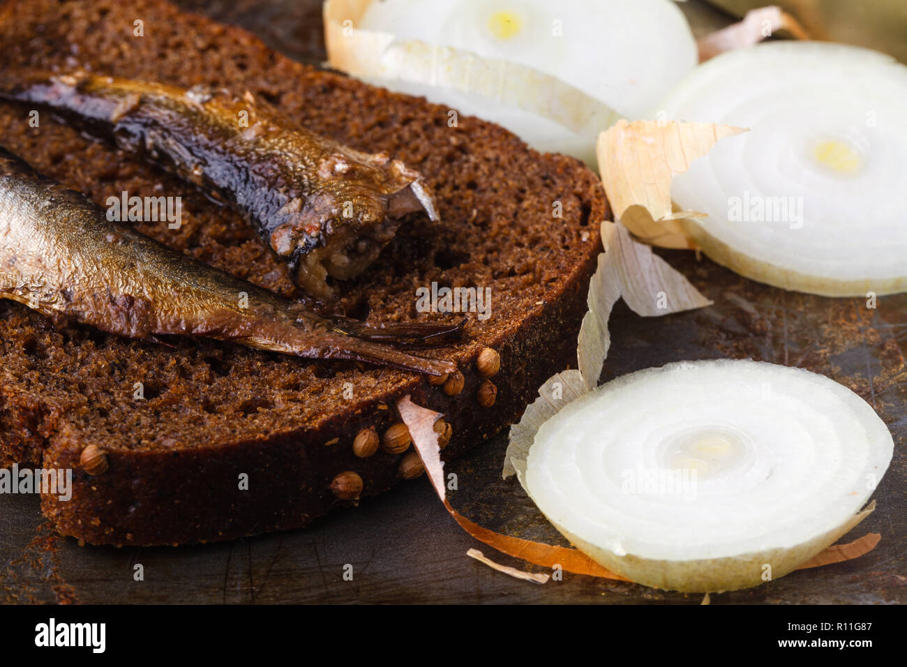 Sprat on a piece of black bread. Fish with bread Stock Photo - Alamy