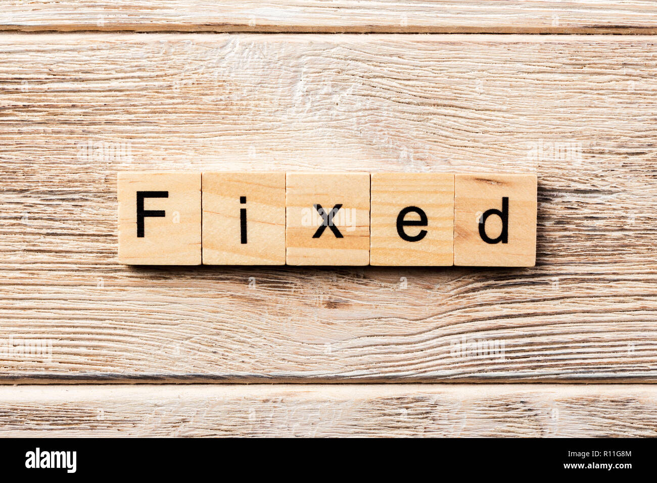 fixed word written on wood block. fixed text on table, concept Stock ...