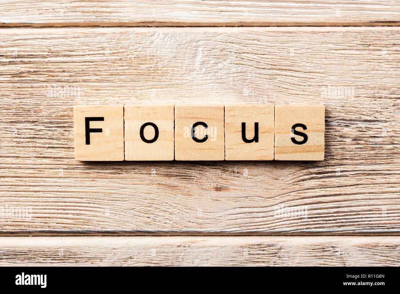 focus word written on wood block. focus text on table, concept Stock ...