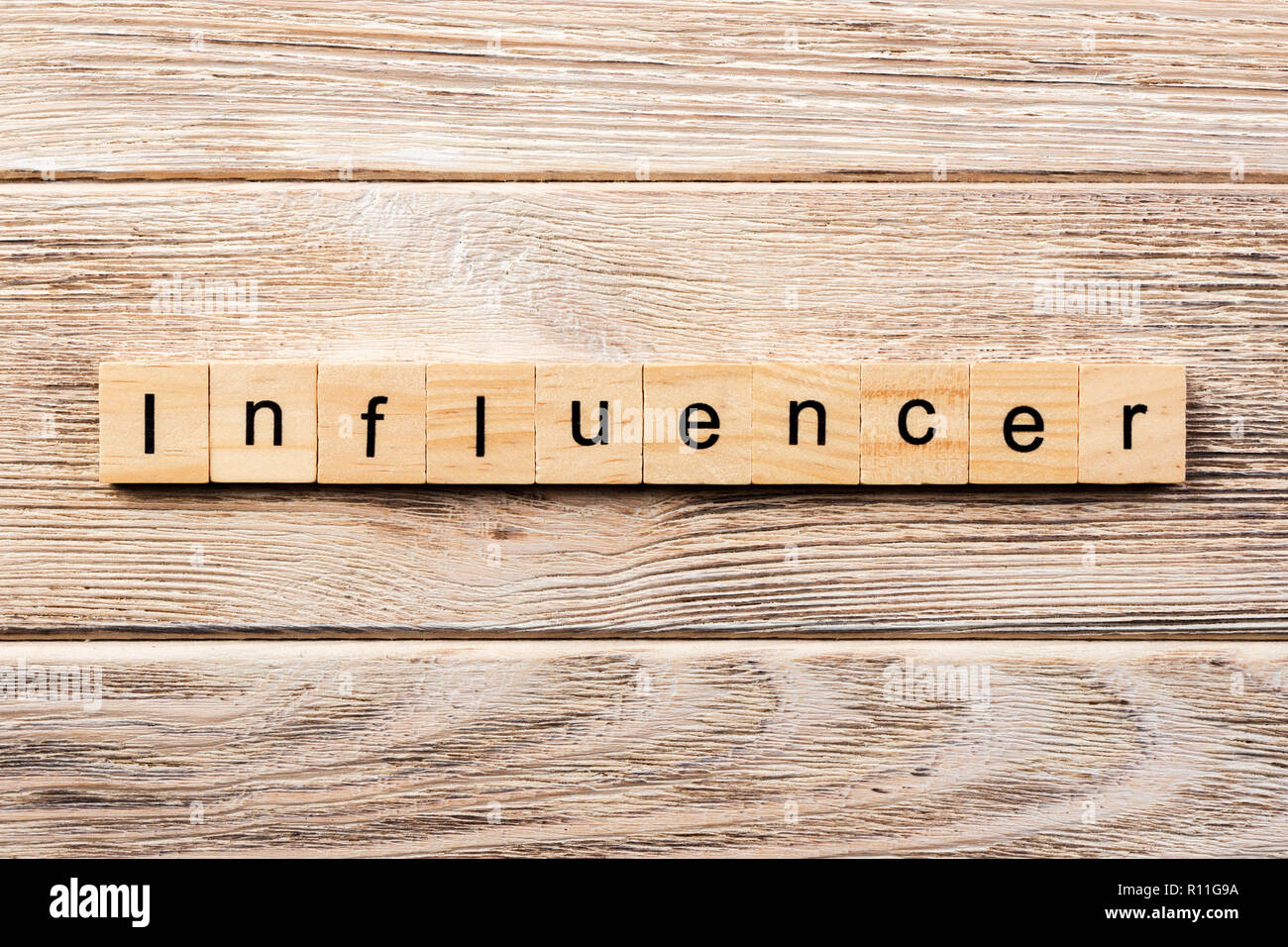 influencer word written on wood block. influencer text on table ...