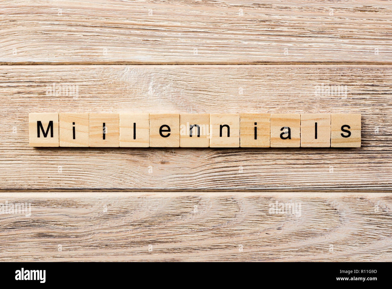millennials word written on wood block. millennials text on table ...