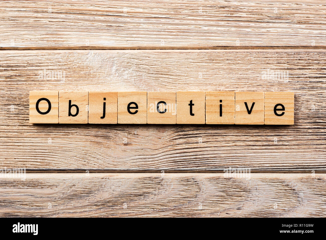 objective word written on wood block. objective text on table, concept ...