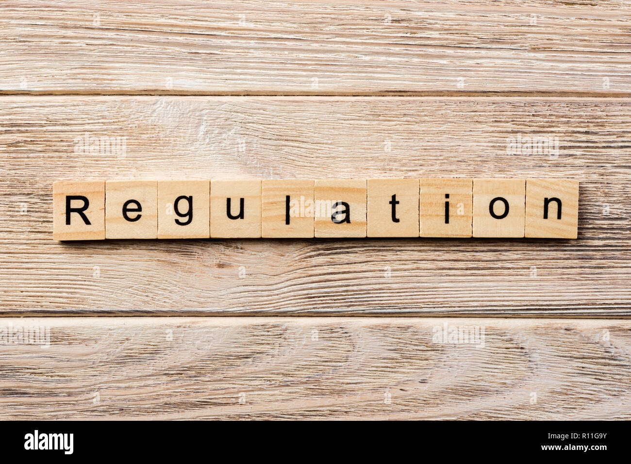 regulation word written on wood block. regulation text on table ...