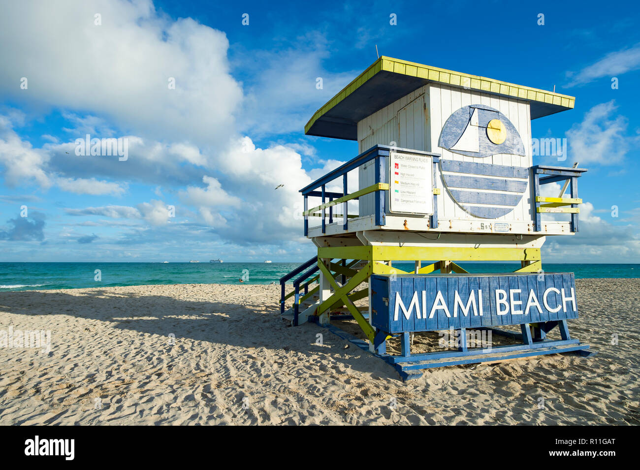Traditional weathered wooden lifeguard tower in faded colors standing ...