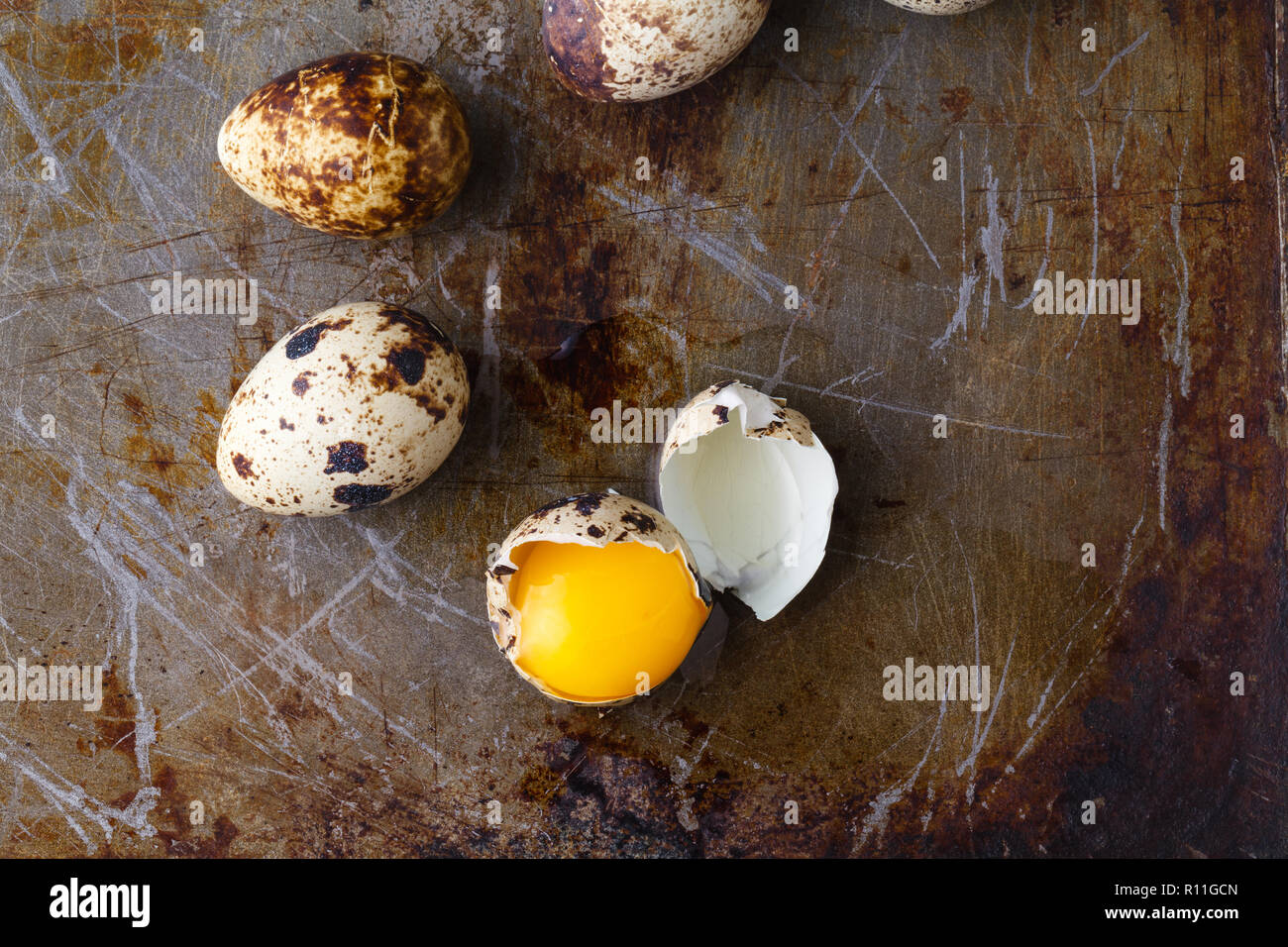 quail egg broken on rustic table Stock Photo - Alamy