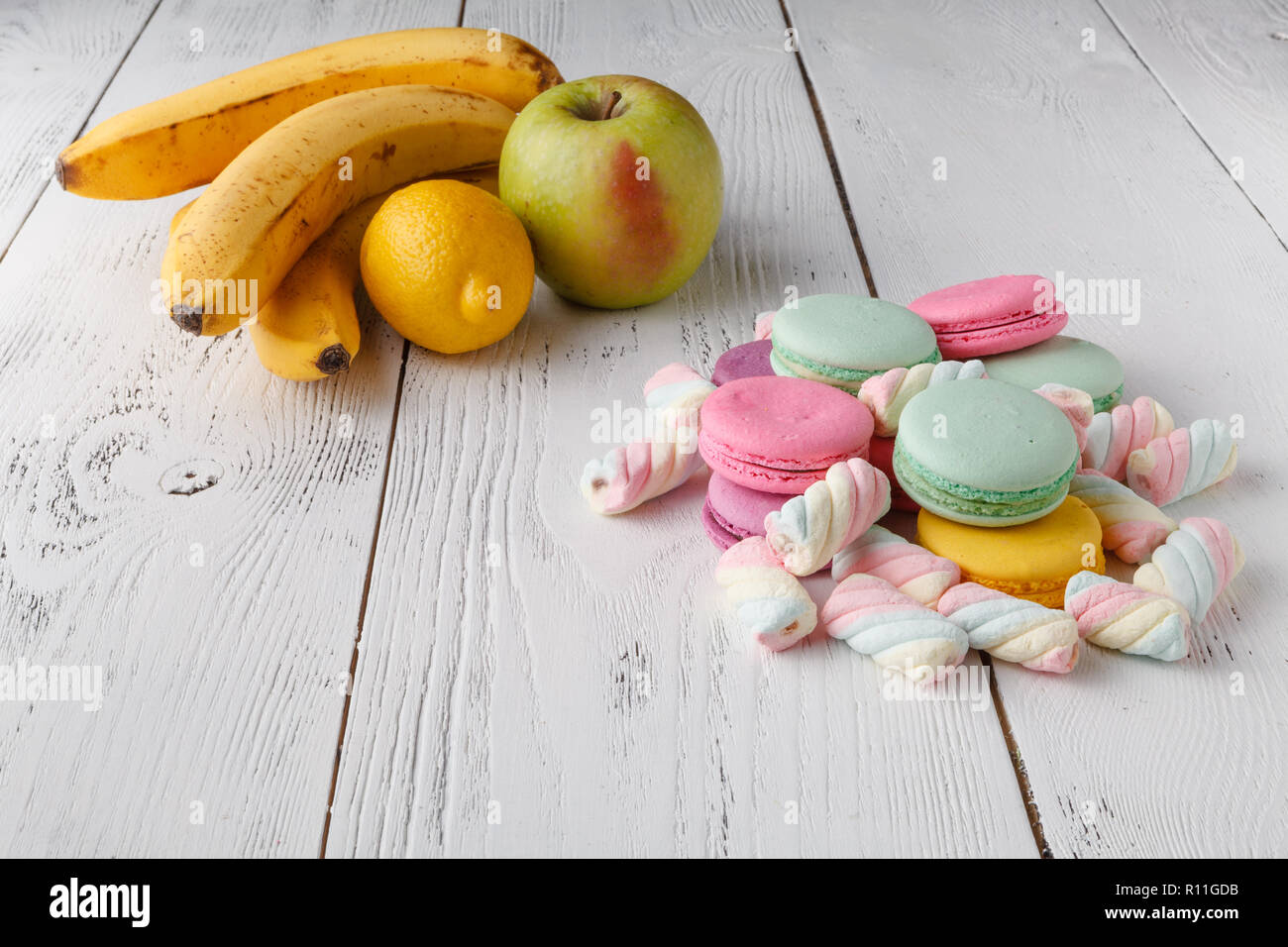 choice fruits vs sweets Stock Photo - Alamy