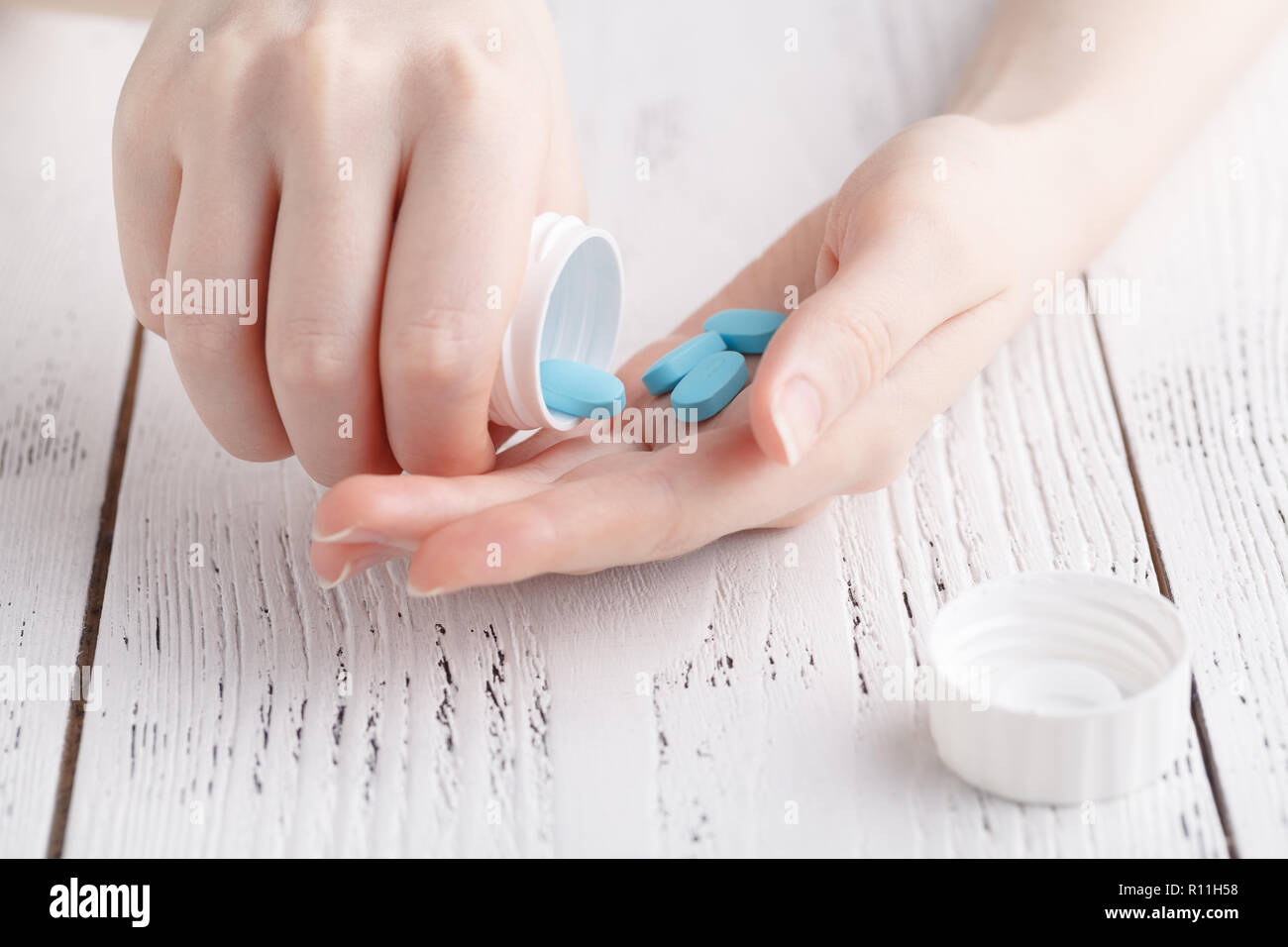 Taking pills, close up view Stock Photo - Alamy
