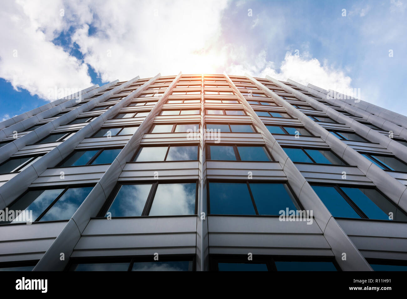 Tall office building with glass windows Stock Photo - Alamy