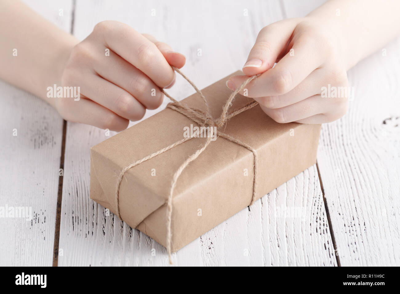 Handmade gift pcking in craft papper by female Stock Photo - Alamy