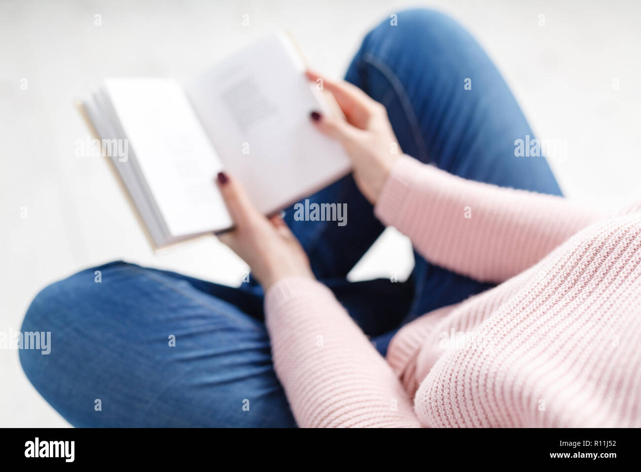 Female reading book in home Stock Photo - Alamy