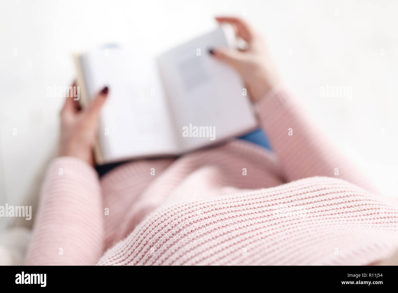 Female reading book in home Stock Photo - Alamy