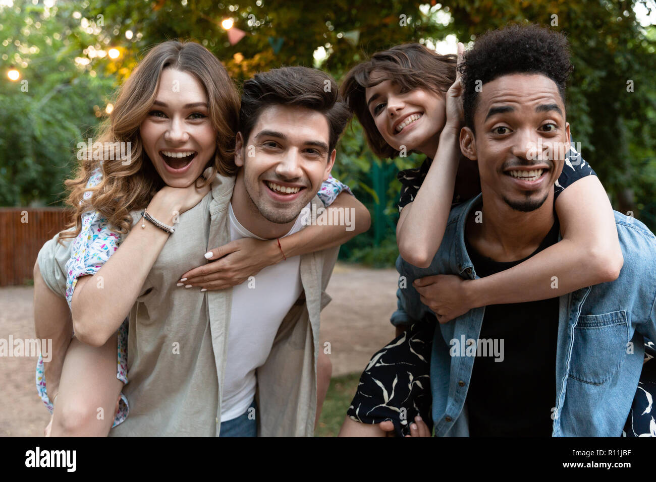 Image of happy group of young friends party outdoors in park having fun ...