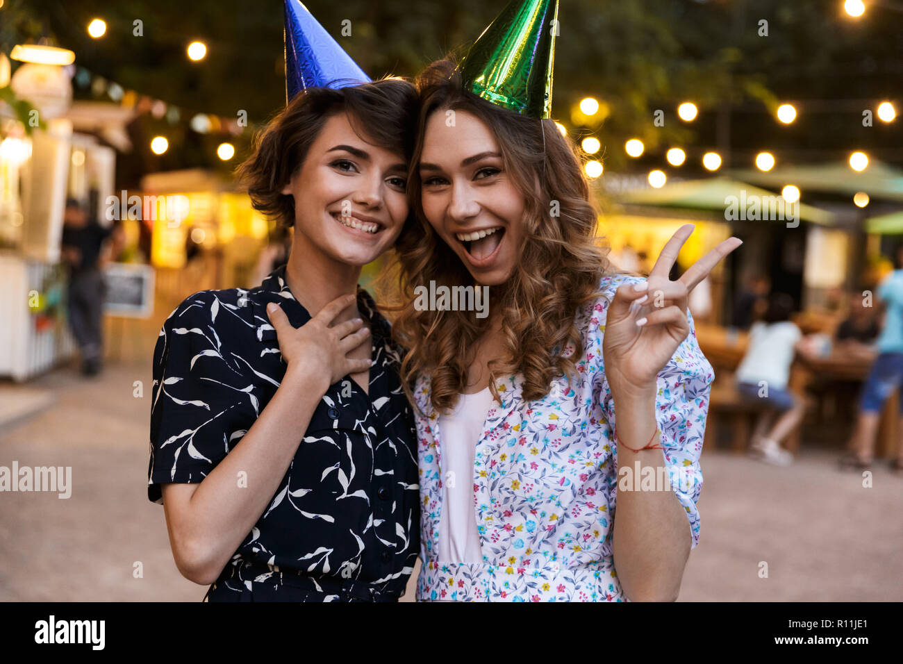 Image of cheerful party emotional young friends women outdoors showing ...