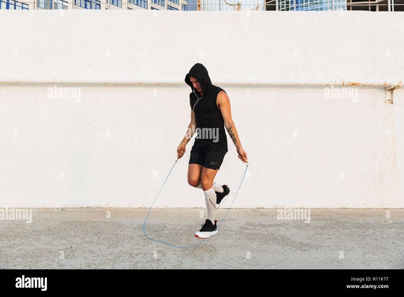 Picture of strong young sportsman outdoors at the beach make sport ...